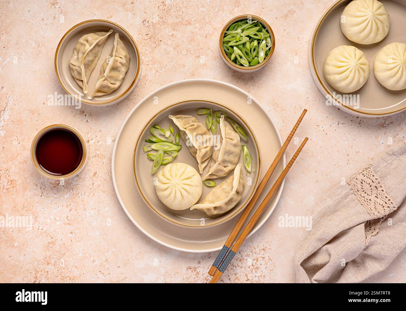 Food photography of steamed duck bao buns and chicken gyoza, spring ...