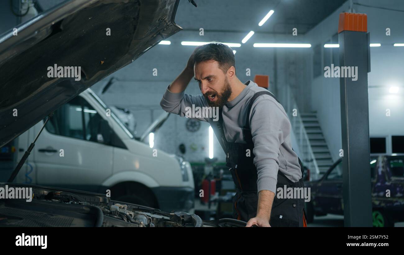 Confused shocked Caucasian guy man auto mechanic male repairman open ...