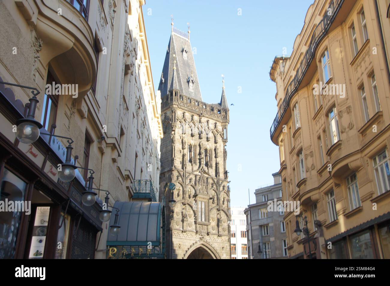 Gothic architecture dominates the narrow street, with a tall, pointed ...