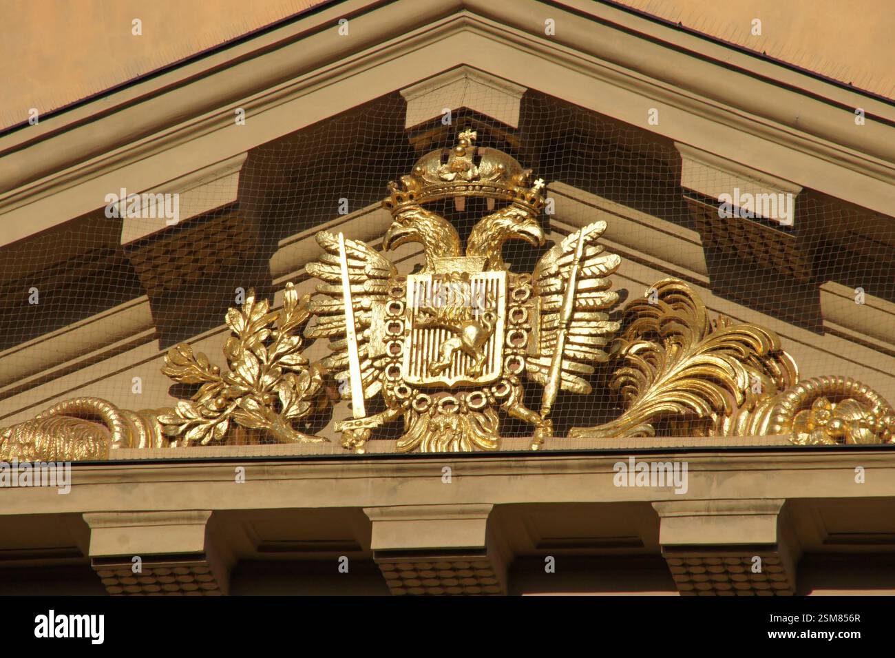Double-headed eagle coat of arms in gold. Crown above, shields on chest ...