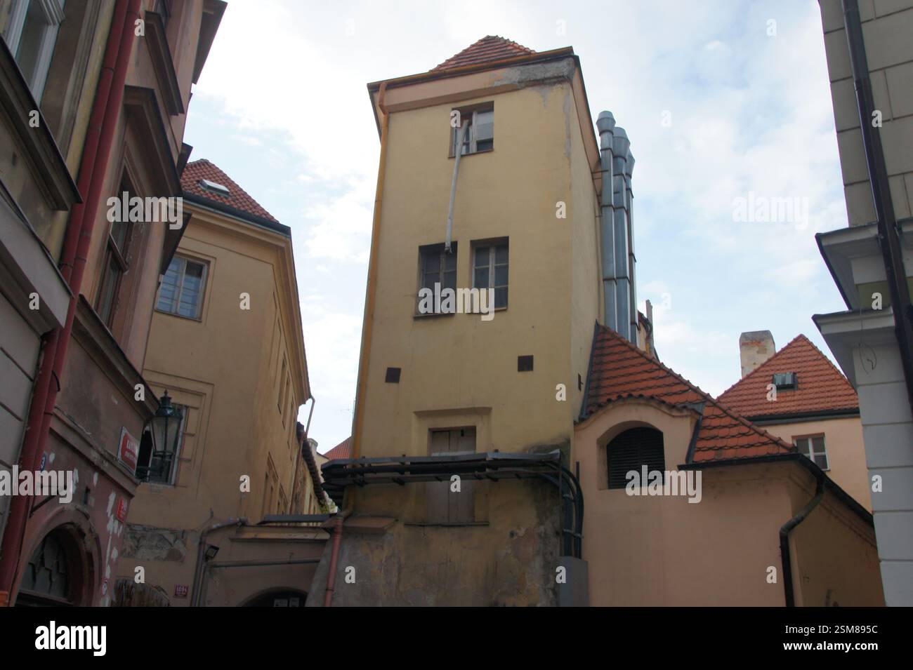 Tall, colorful buildings line a narrow alleyway. The buildings have ...