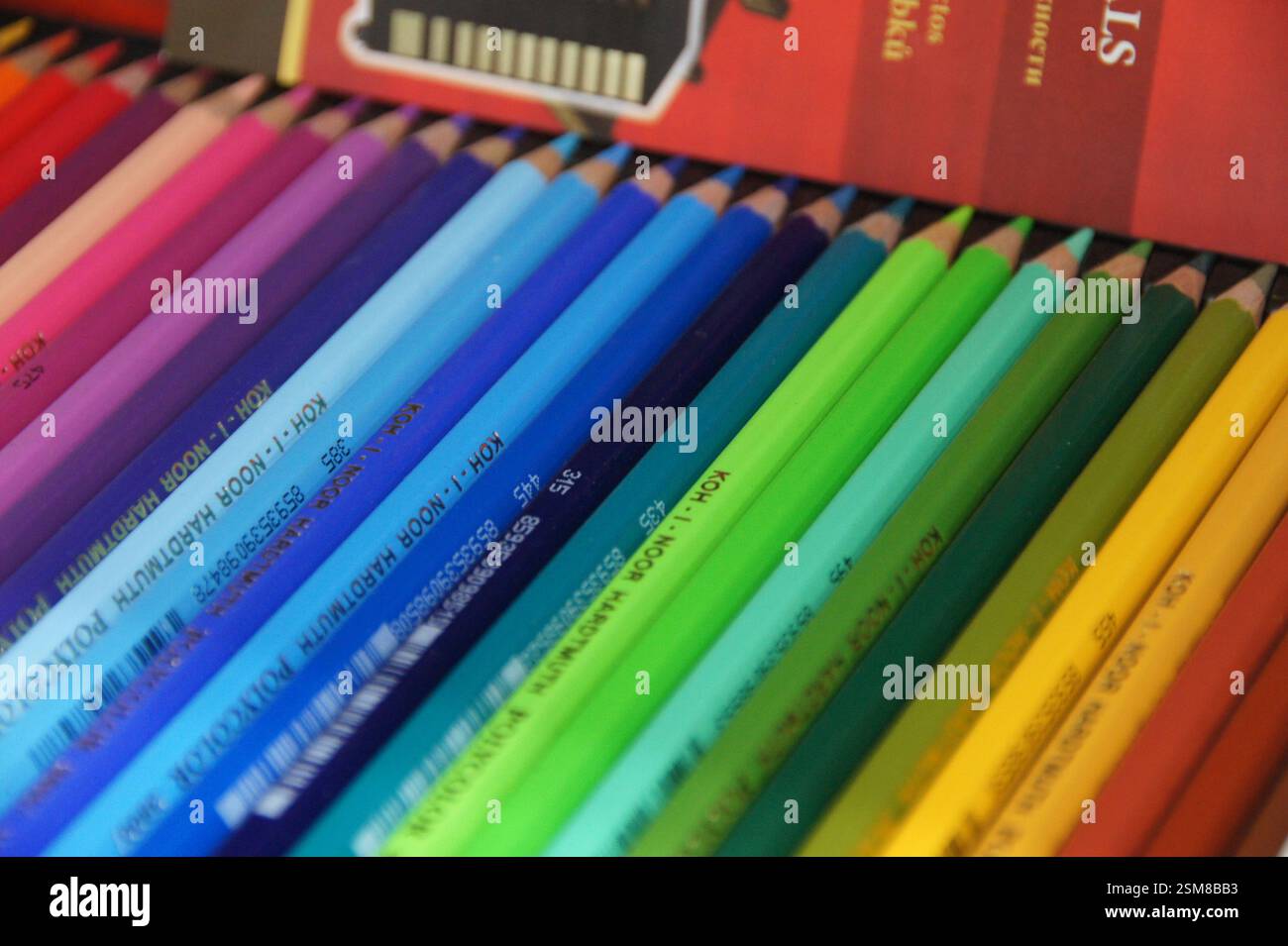 Coloured pencils. Brightly coloured pencils arranged in a row, ready ...