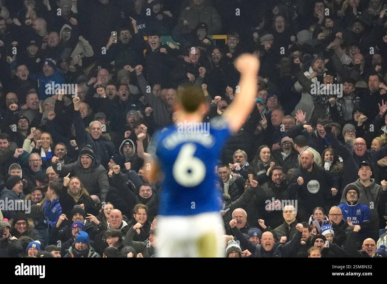 Everton's James Tarkowski celebrates with fans in the background after ...