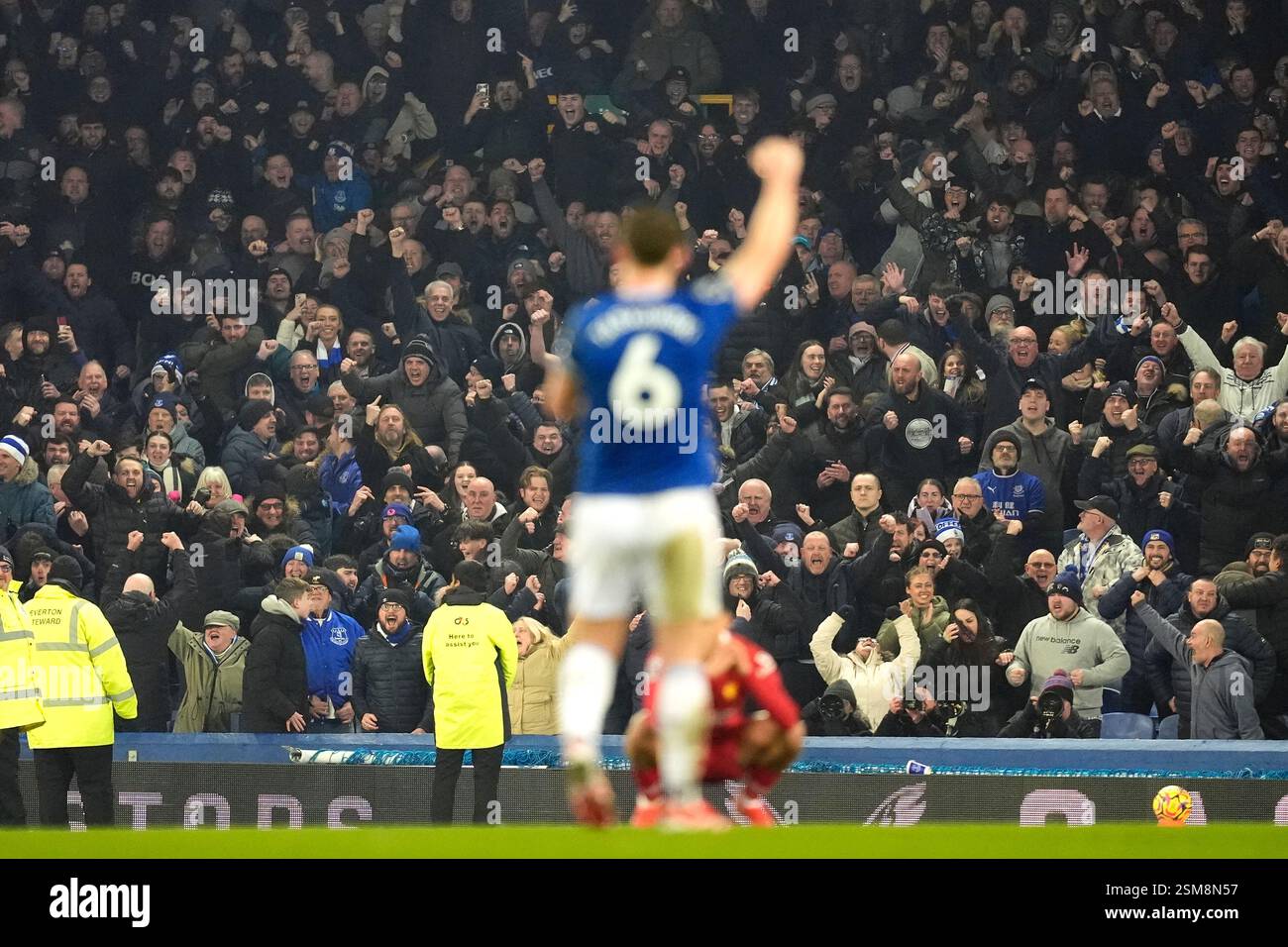 Everton's James Tarkowski celebrates with fans in the background after ...