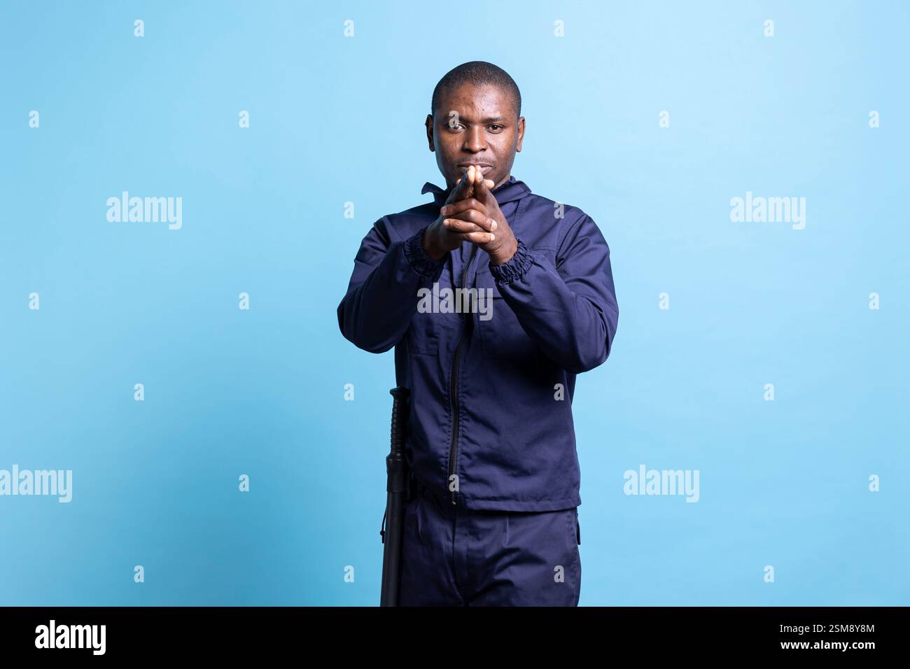 African american security agent mimicking target shooting with an ...