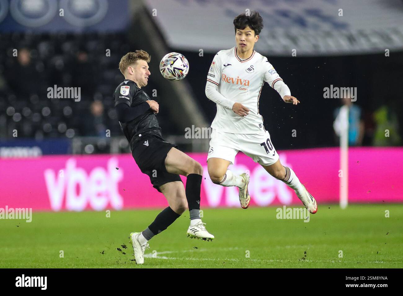 Swansea, UK. 12th Feb, 2025. Eom Ji-Sung of Swansea City beats Stuart ...