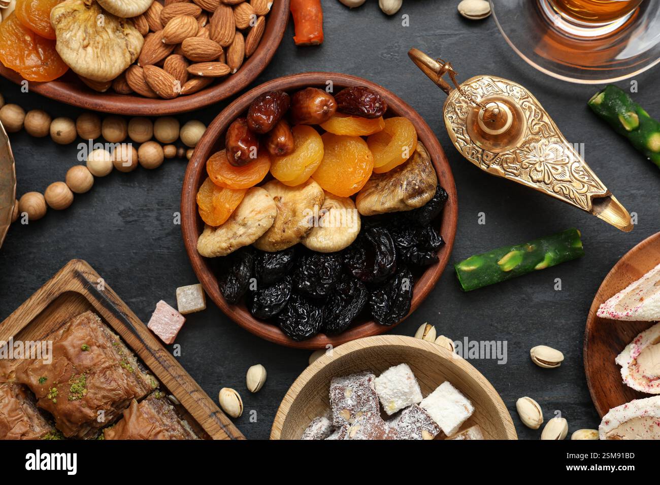 Composition with traditional Eastern sweets, Aladdin lamp and tasbih ...