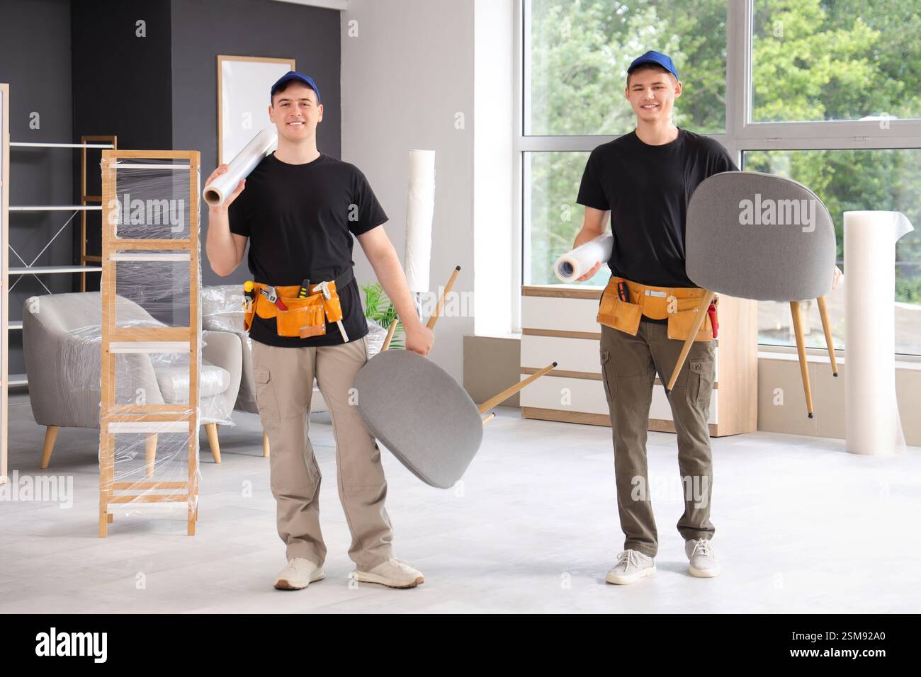 Men carrying chairs hi-res stock photography and images - Alamy