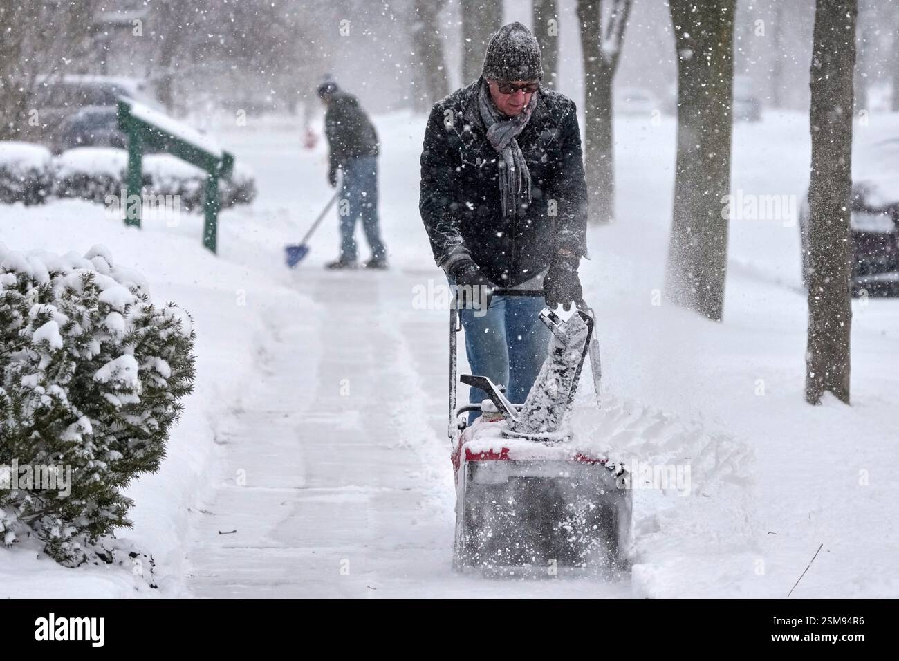 Michael Frabishak uses a snow blower during a snowfall Wednesday, Feb ...