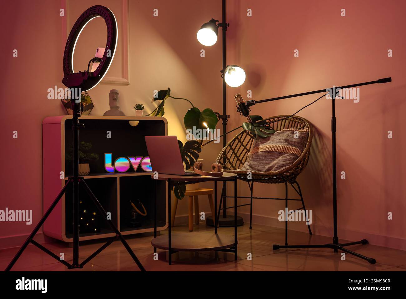 Interior of blogger's studio with armchair, table and glowing lamp at ...