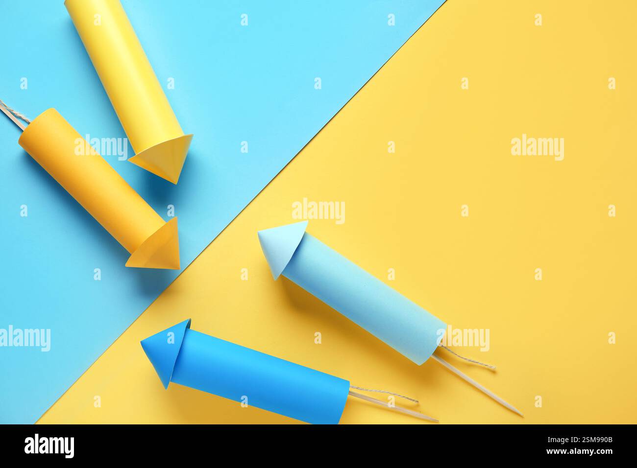 Blue and yellow firework rockets on color background Stock Photo - Alamy
