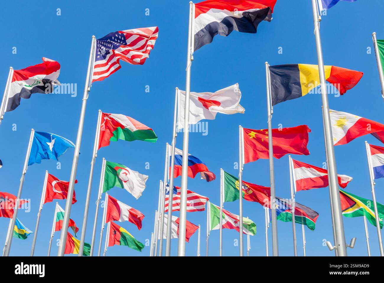 Many world's countries national flags waving together on the wind, with ...