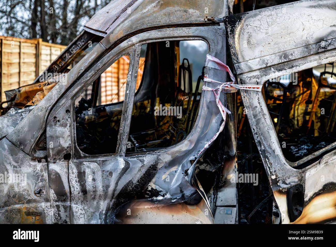 Close-up of a burnt out van, highlighting the devastating effects of ...