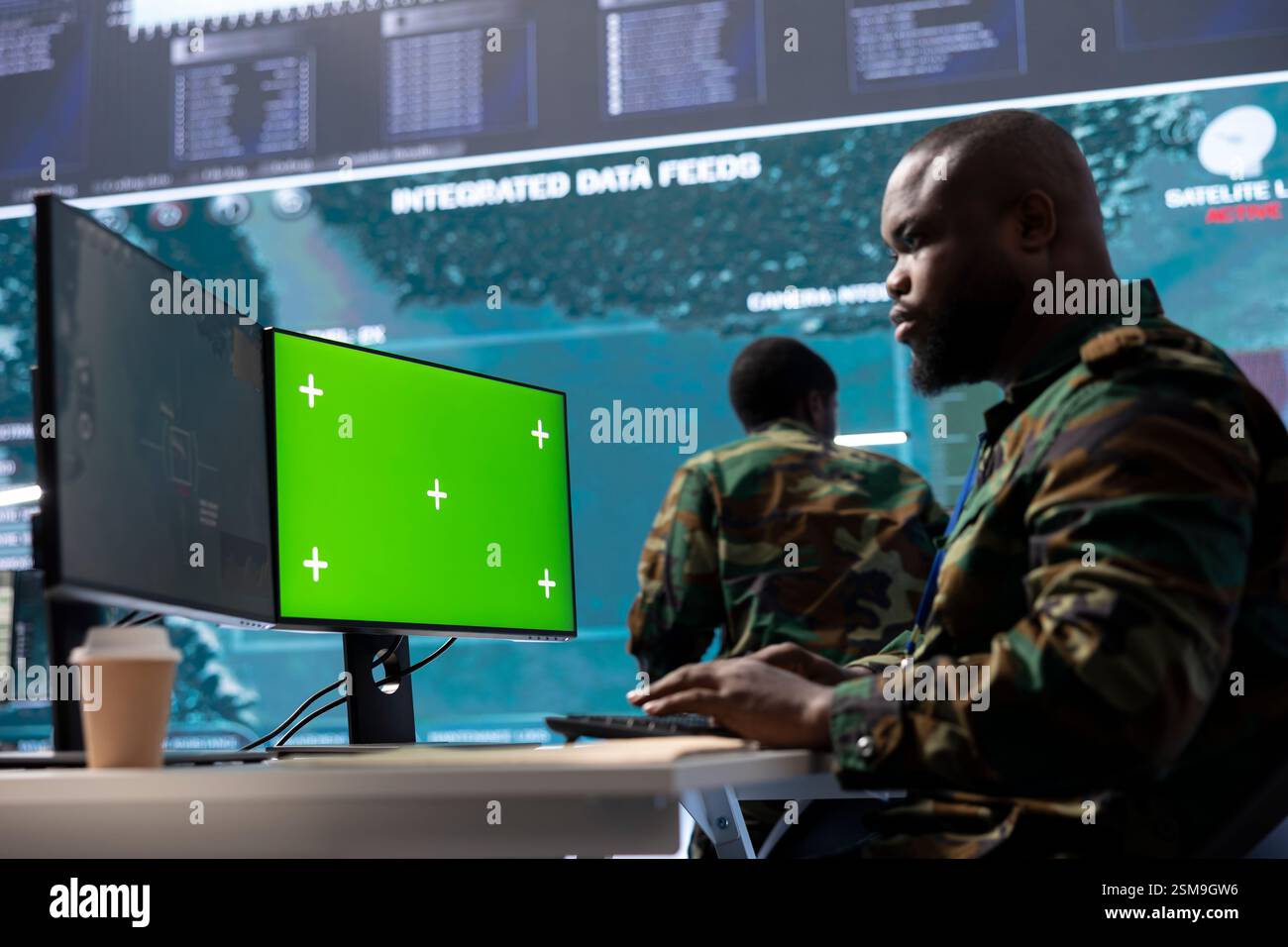 Military expert handles satellite cctv data next to mockup screen ...