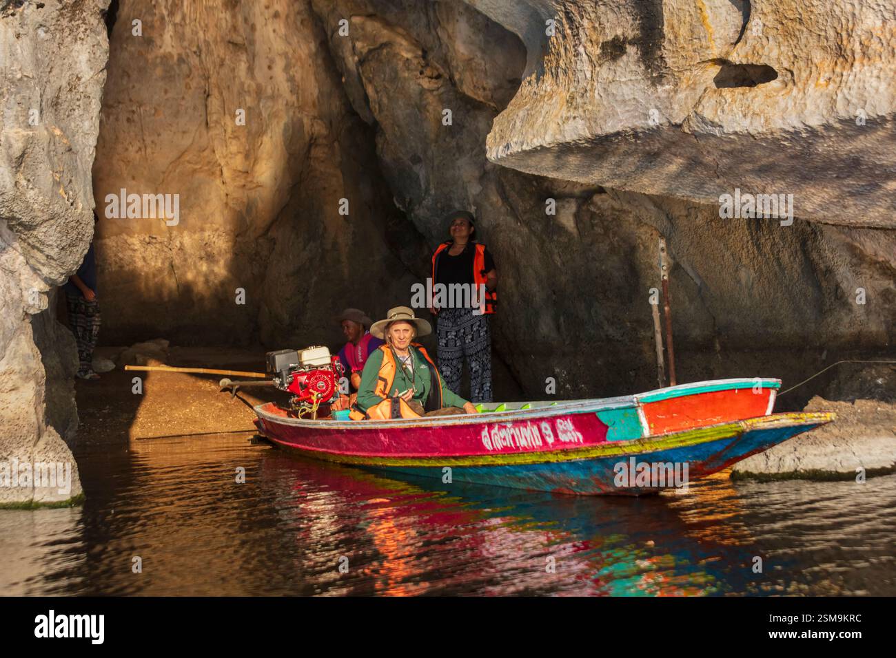 A boat ride surrounded bhy limestone mountains rising above the inland ...