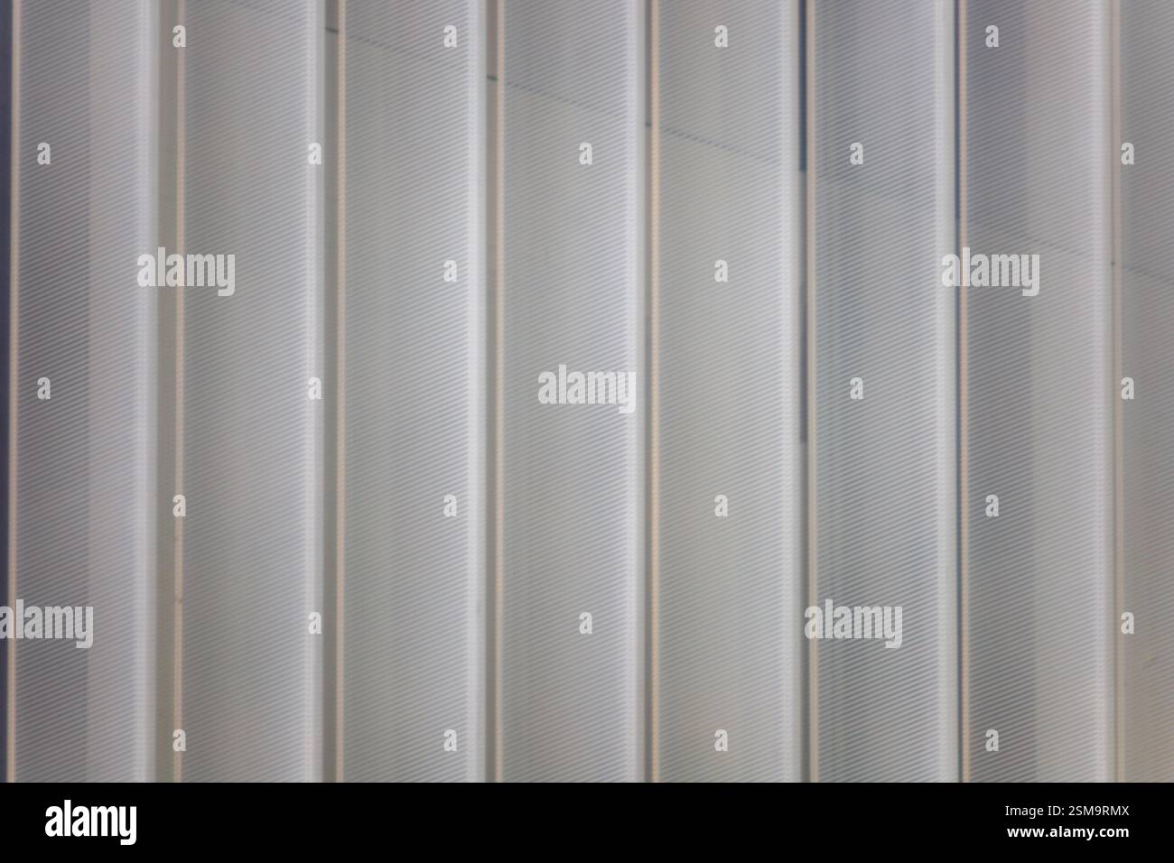 Modern Building Exterior with Vertical Metallic Lines and Glass Facade ...
