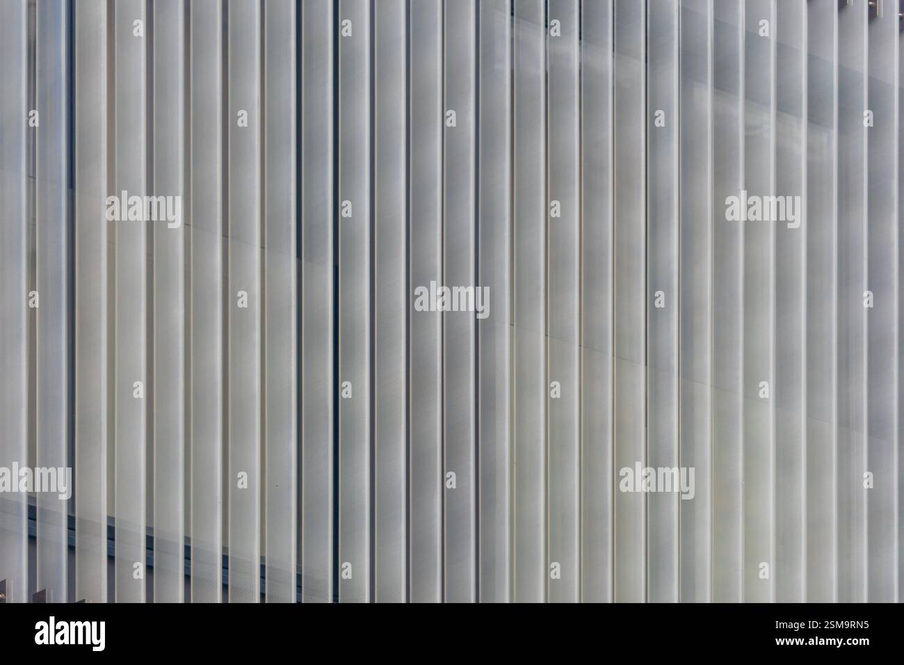 Modern Building Exterior with Vertical Metallic Lines and Glass Facade ...