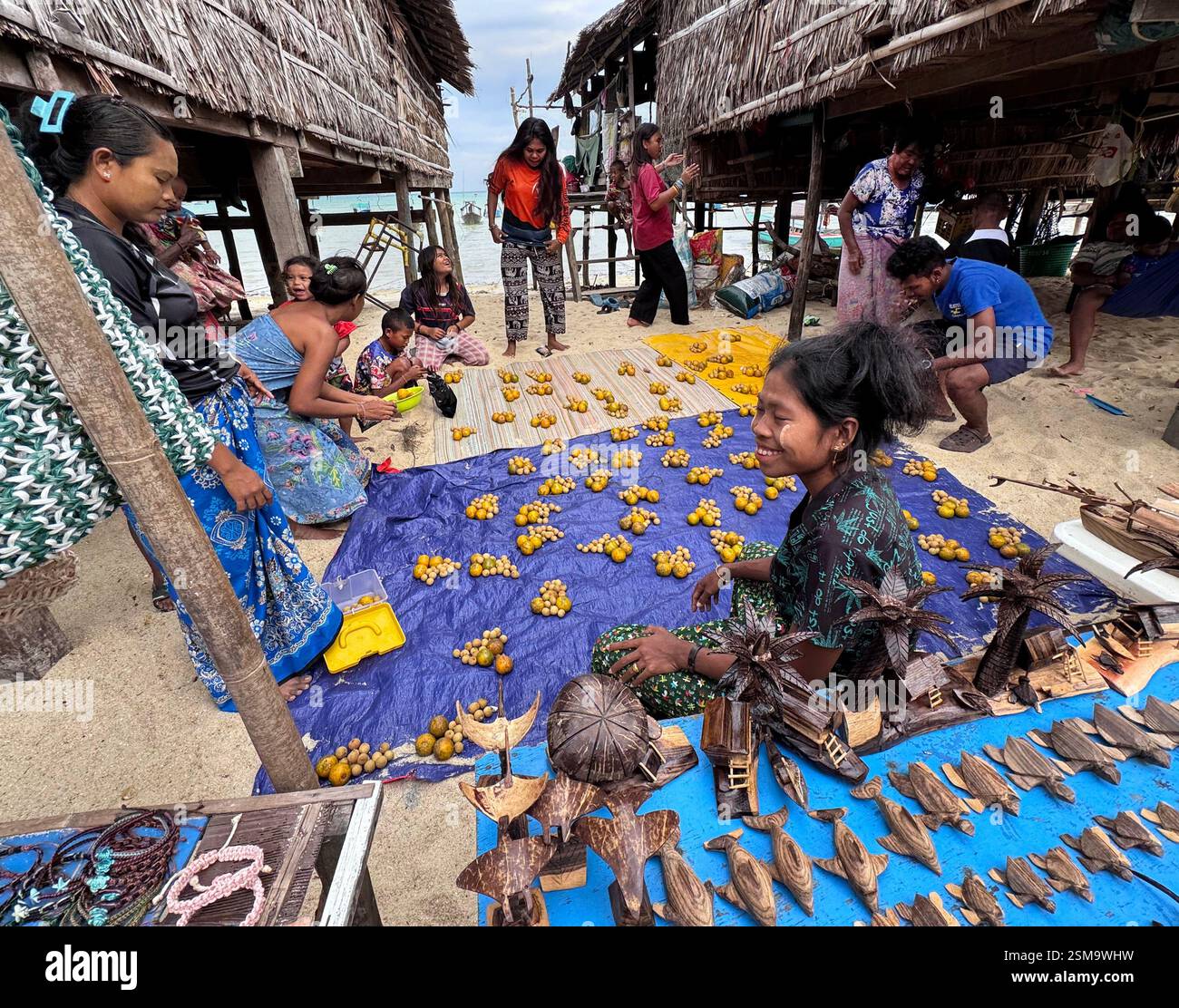 Moken Sea Gypsy people share fruit in the village of Ao Bon Yai on ...