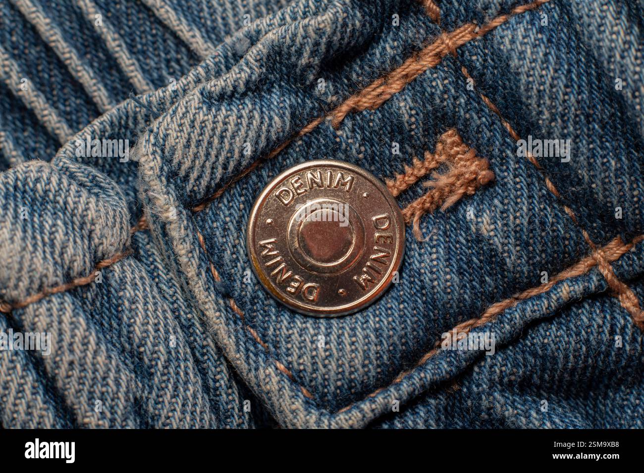 Button and seams of a denim garment Stock Photo - Alamy