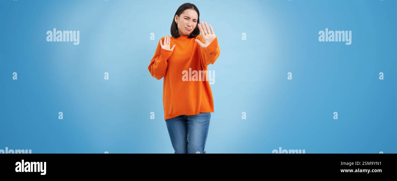 Stop it, no photos please. Upset asian girl blocks camera with hands ...