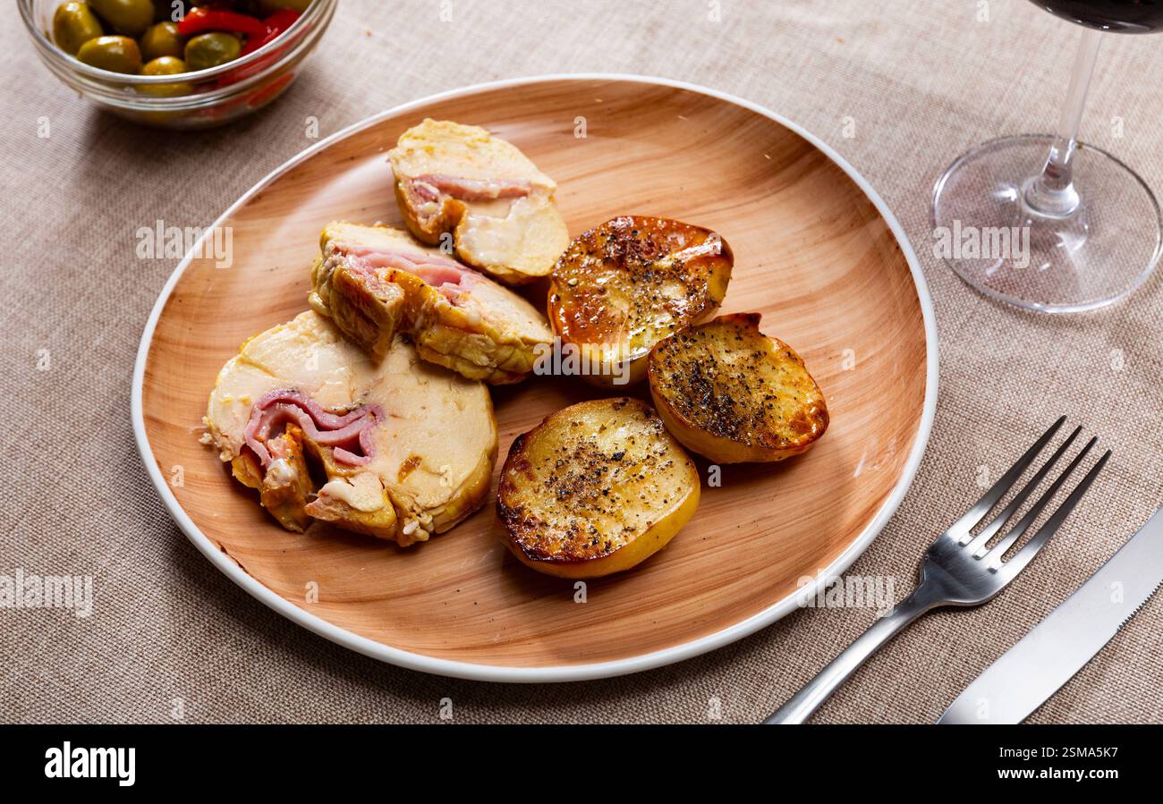 Chicken fillet baked with bacon filling, garnished with fried potato ...