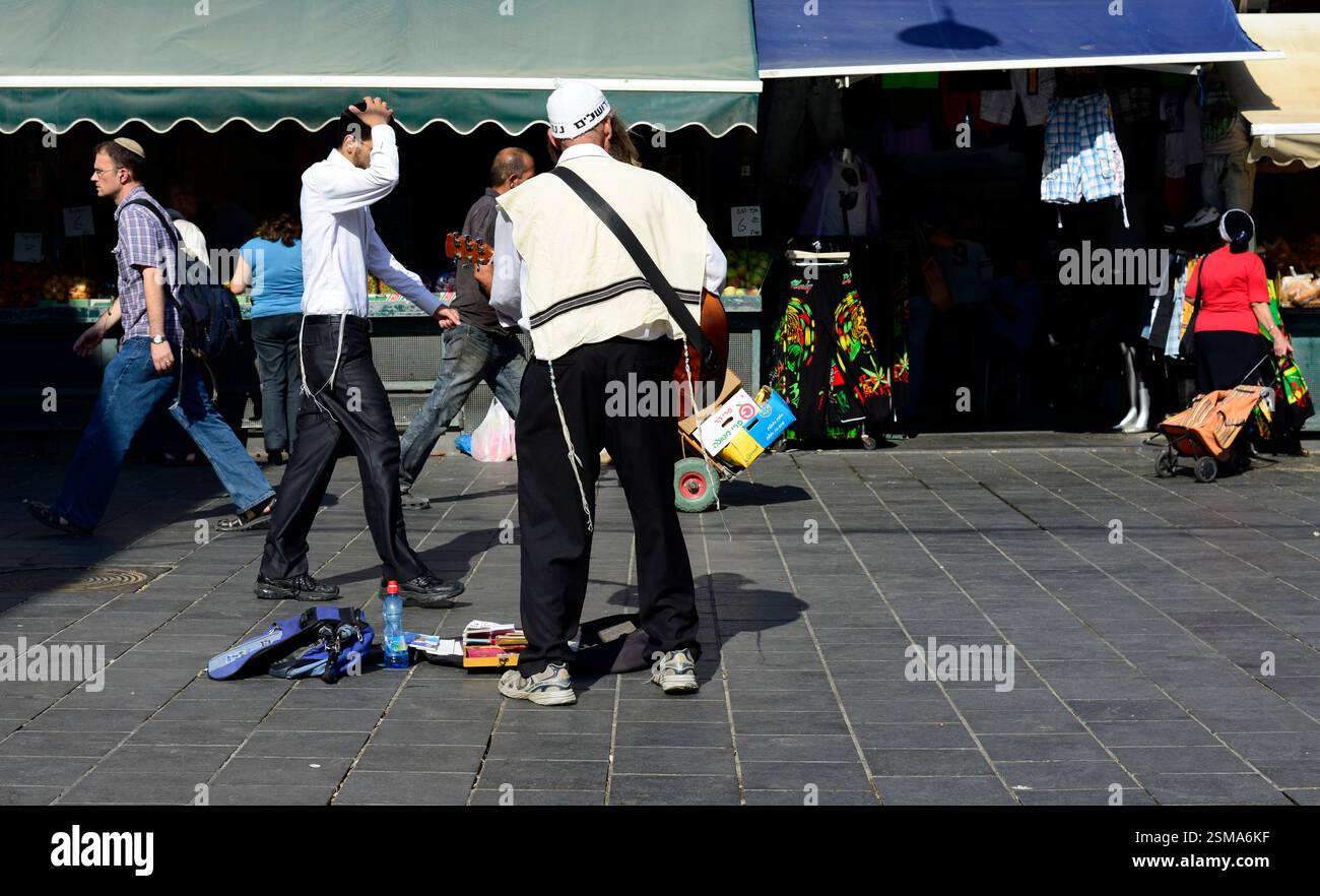 A Breslov Jewish man playing music at the Mahane Yehuda market in ...