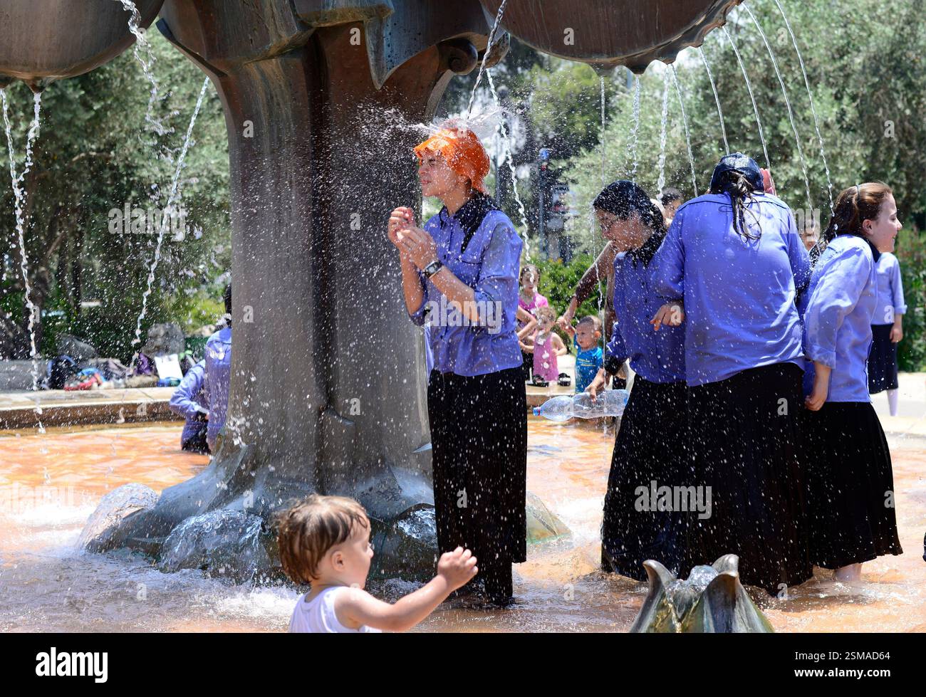 Girls having fun in the water of the Lions fountain in Jerusalem ...