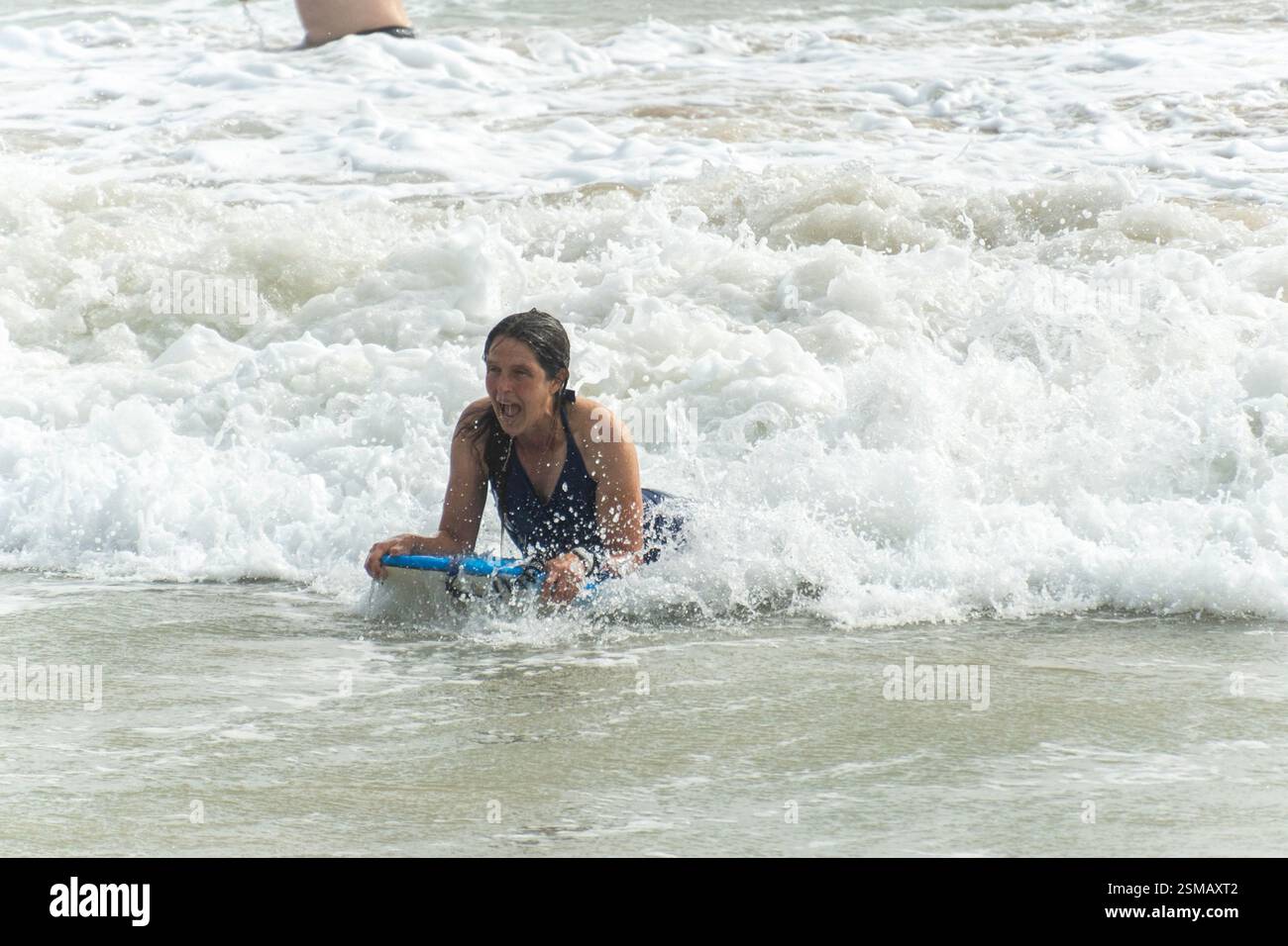 boogie boarding at Poipu beach Stock Photo - Alamy