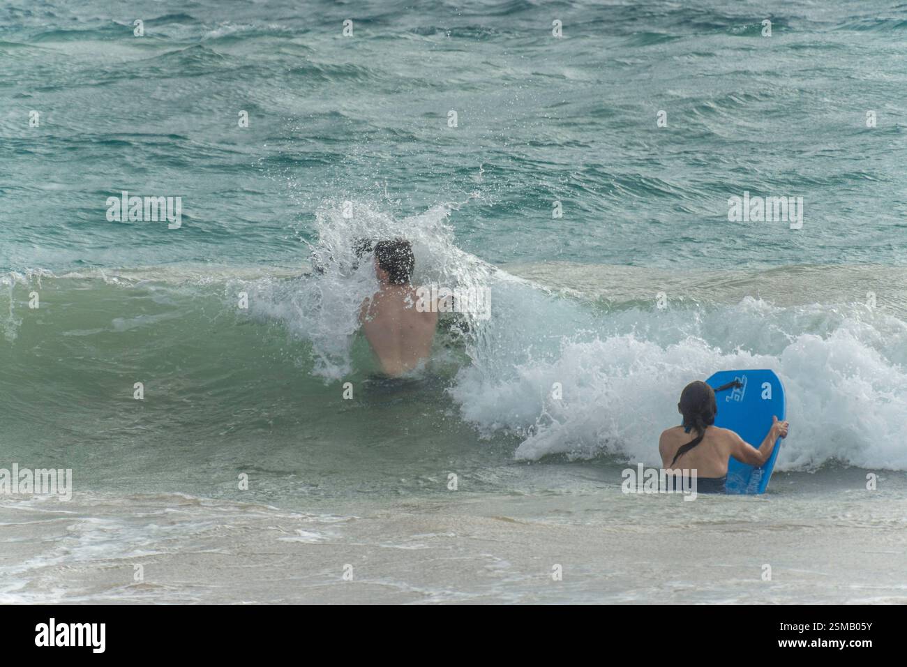 boogie boarding at Poipu beach Stock Photo - Alamy