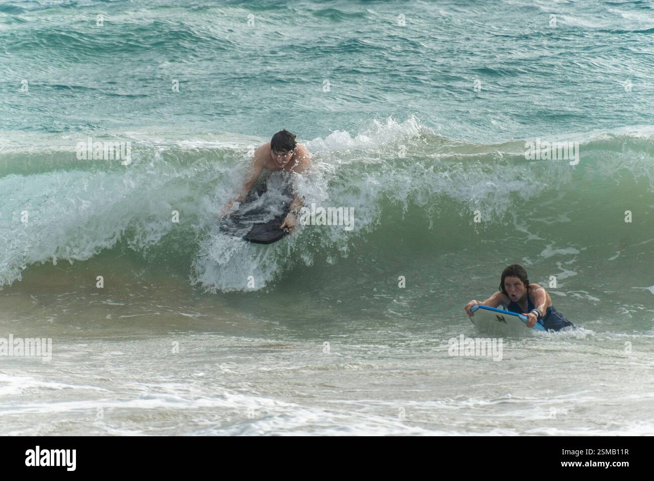 boogie boarding at Poipu beach Stock Photo - Alamy