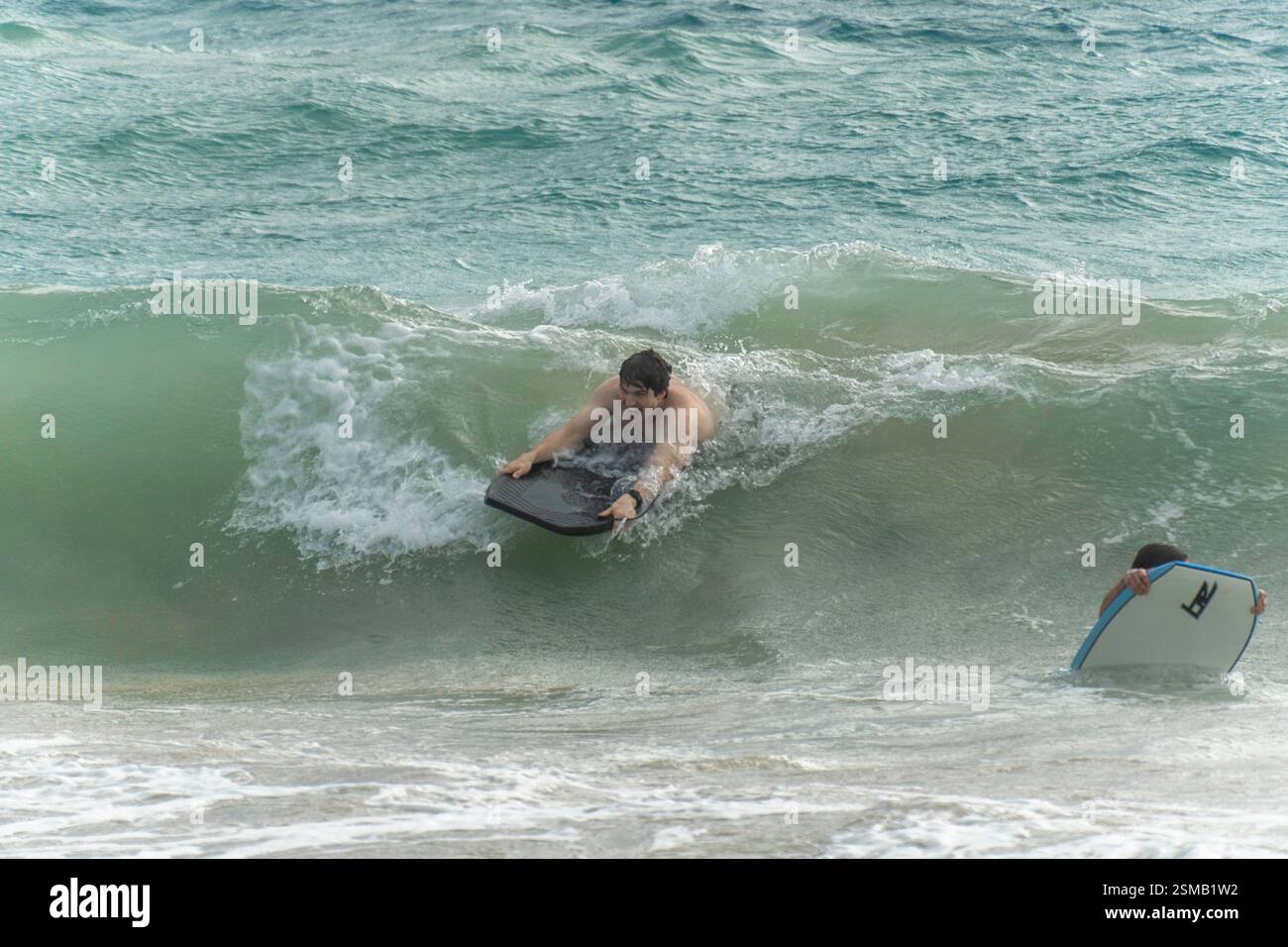 boogie boarding at Poipu beach Stock Photo - Alamy