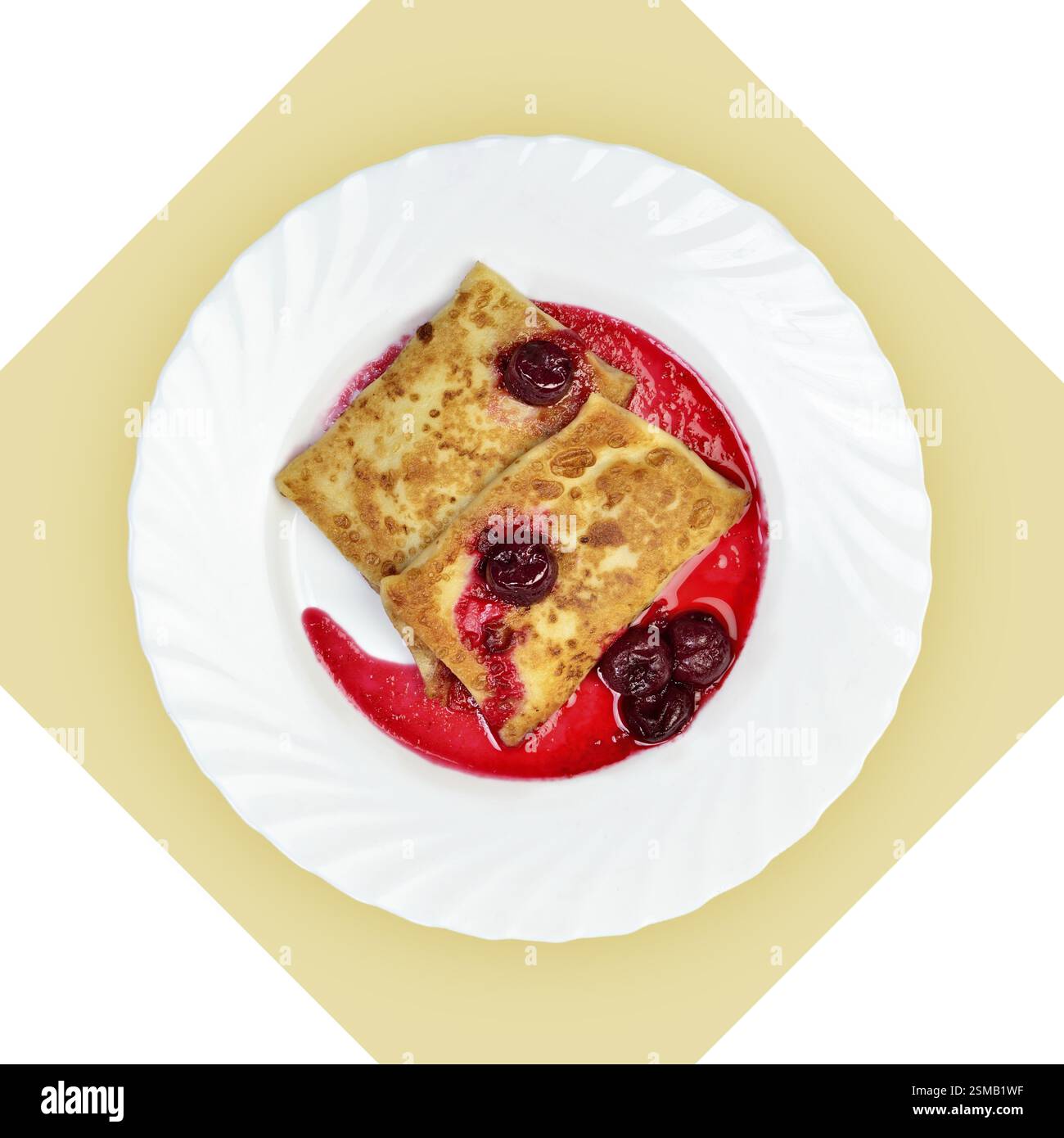 Dish of crepes with cherry sause on white plate. Isolated image with ...