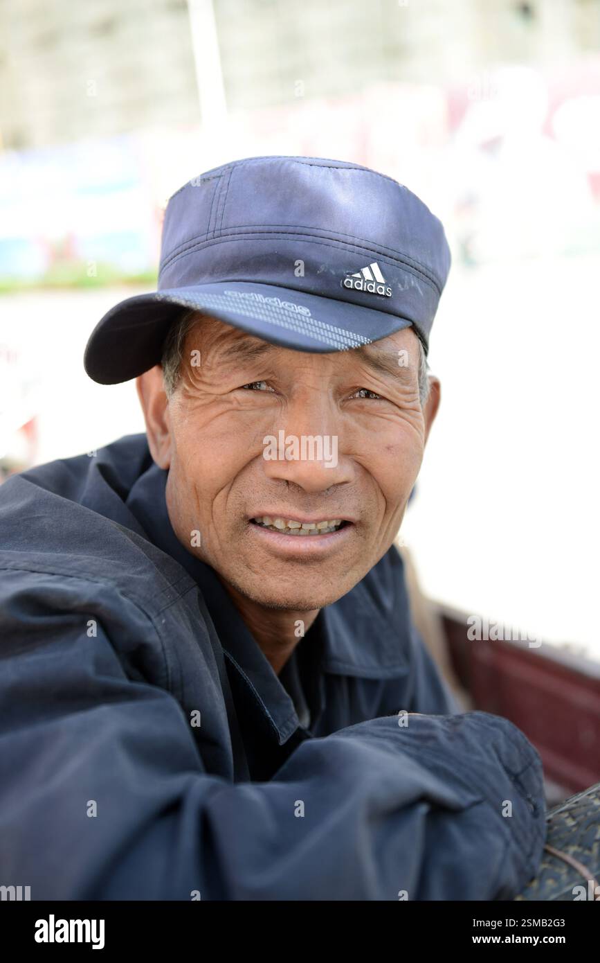 Portrait of a Chinese man wearing an Adidas cap. Photo taken in Zhangye ...