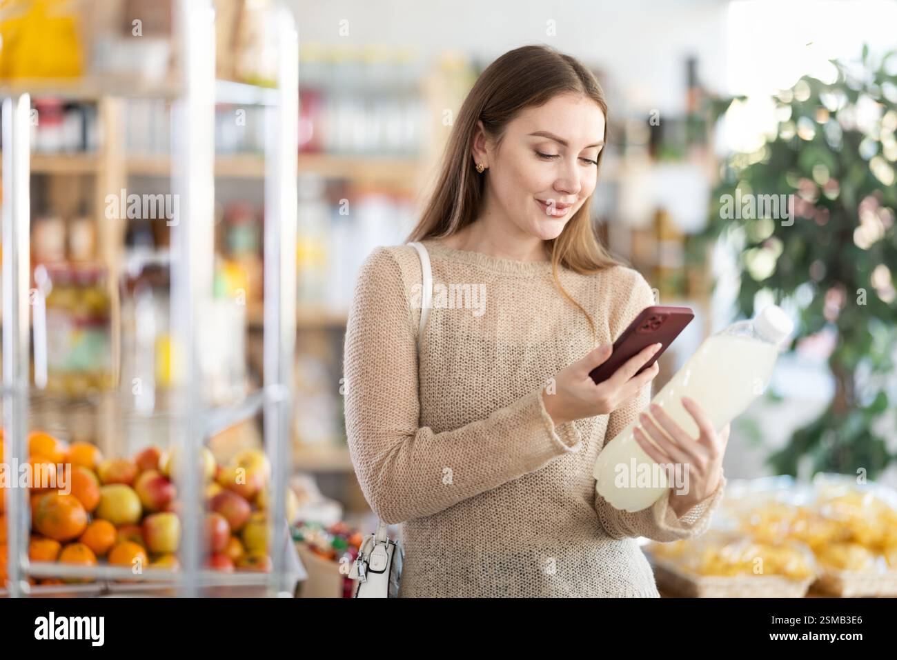 Woman scanning QR code or barcode bottle of water in supermarket Stock ...