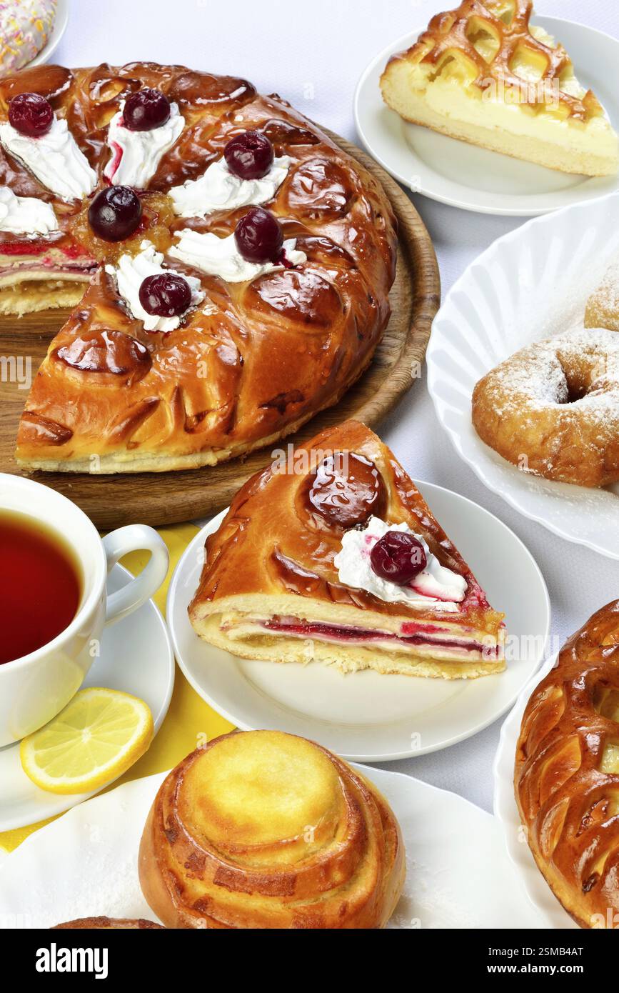 Still life of setout table with baking pies, donuts and tee cup . Image ...