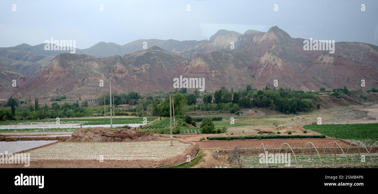 Agricultural farms by the arid mountains in Gansu province, China Stock ...