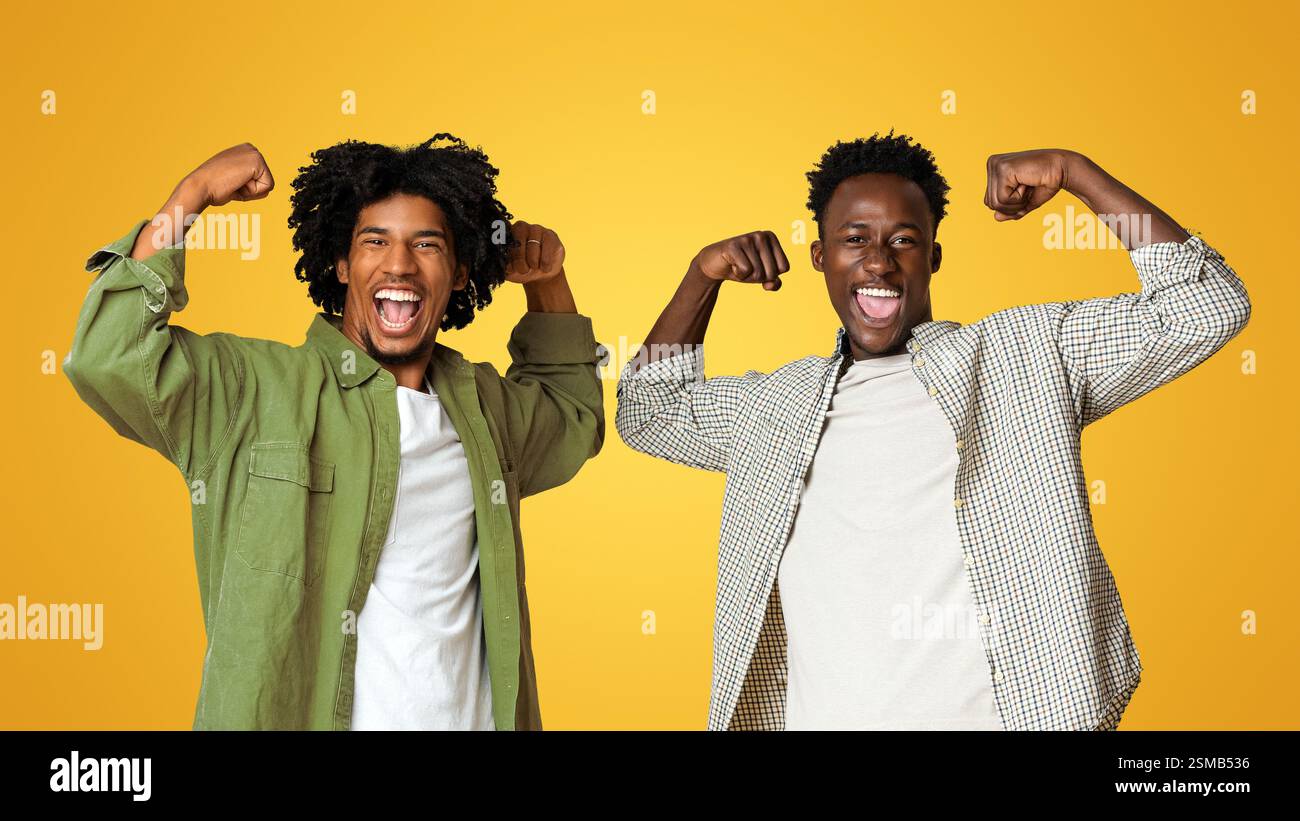 Two Cheerful Black Guys Raising Fists, Showing Biceps At Camera Stock ...