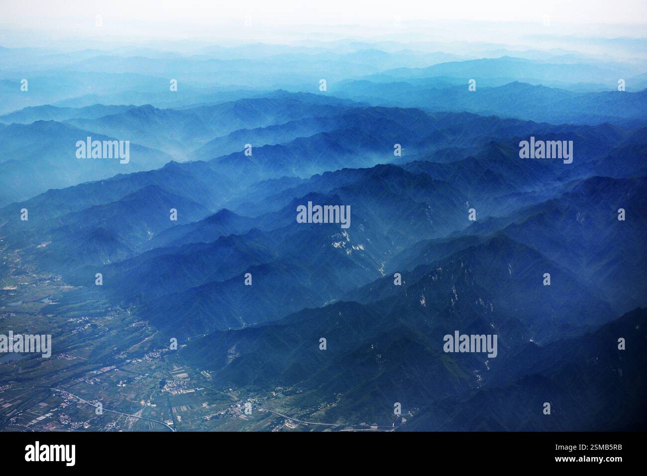Aerial View of Endless Mountain Ranges Covered by Soft Hazy Layers ...