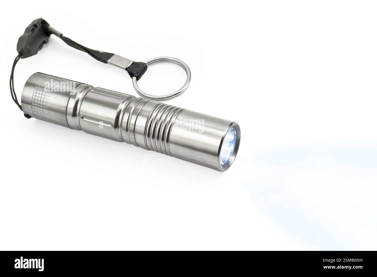 A small silver lamp, a beam of blue light isolated on white background ...