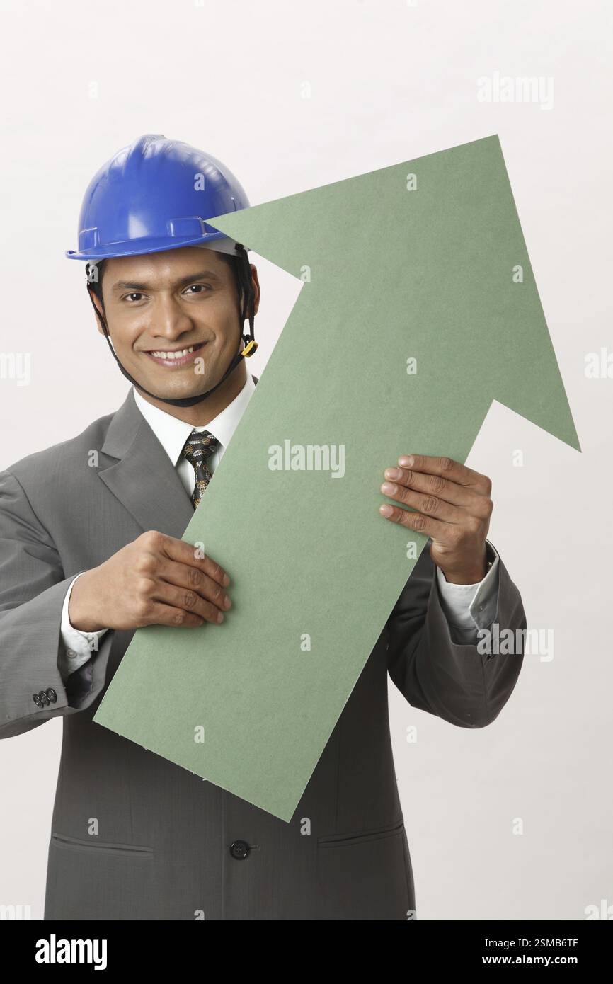 Businessman wearing blue helmet with holding big size green color ...