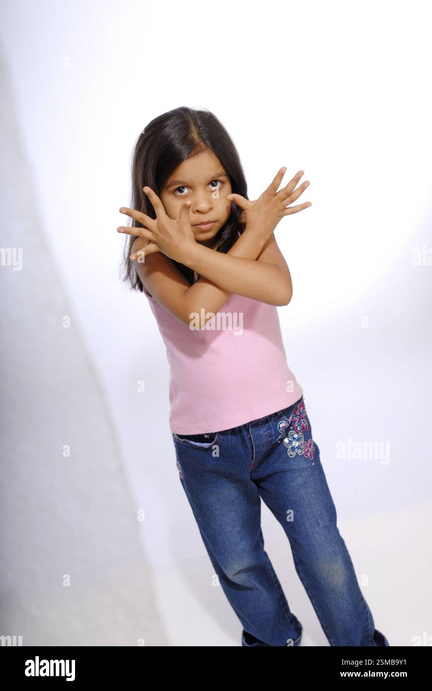 South Asian Indian girl standing showing hands cross pose MR#477 Stock Photo - Alamy
