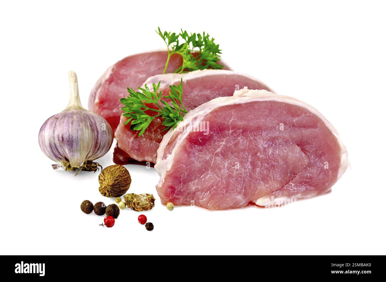 Three pork meat slice, parsley, peppercorns, garlic, nutmeg isolated on ...