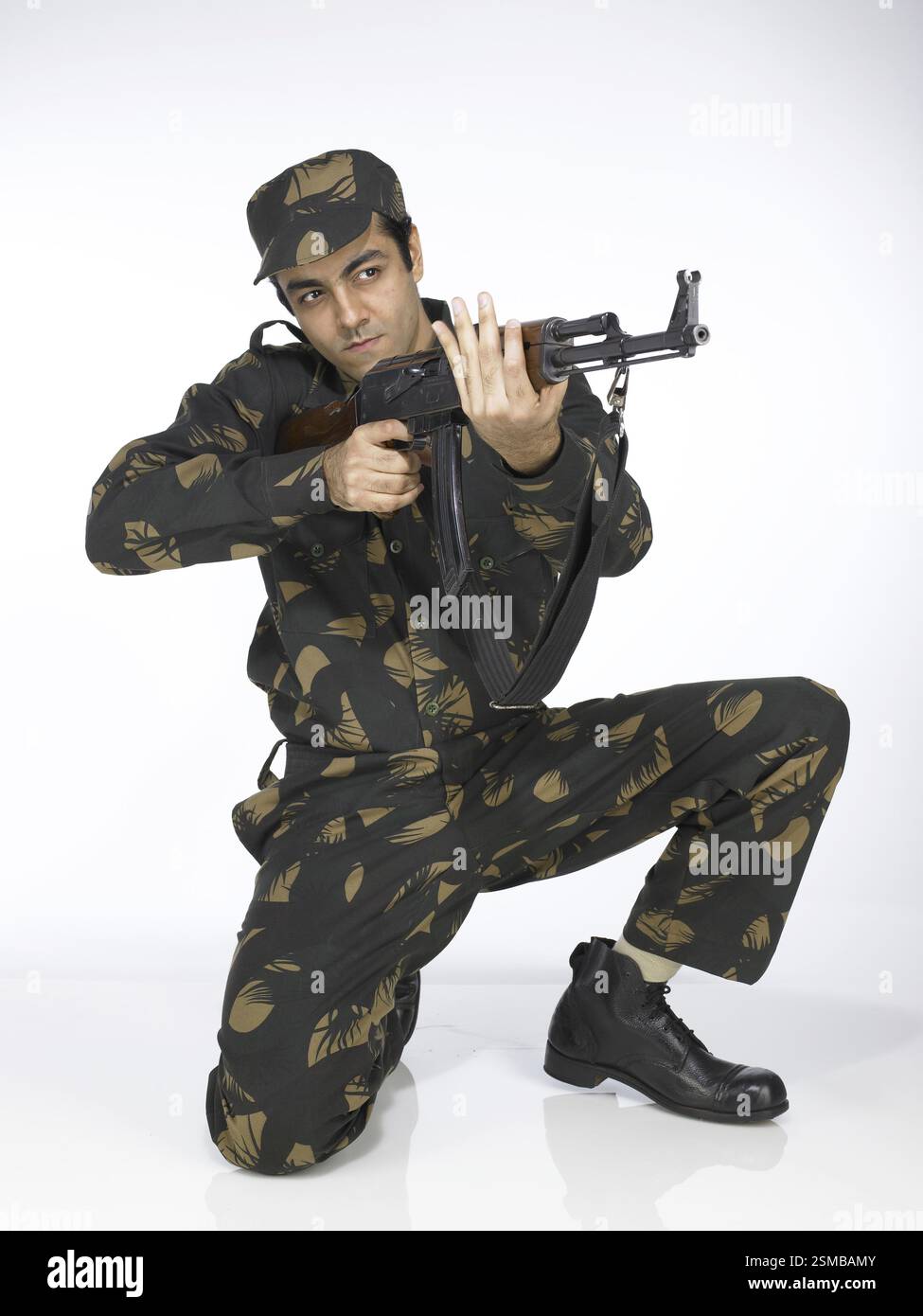 Indian army soldier sitting on knee pointing AK-47 gun MR#702A Stock ...