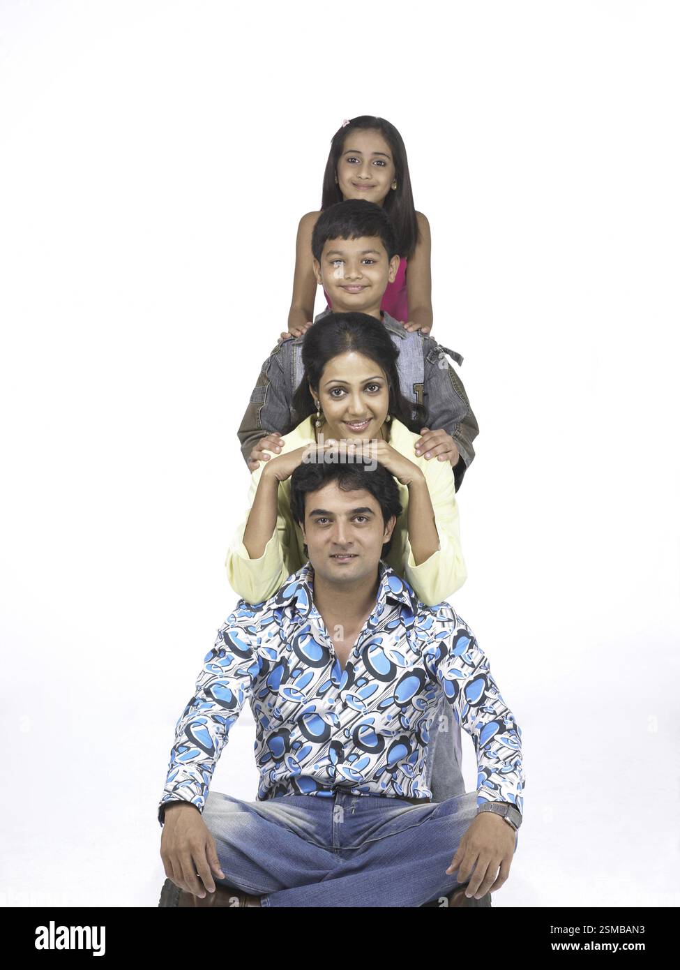 South Asian Indian family with father mother son and daughter sitting ...