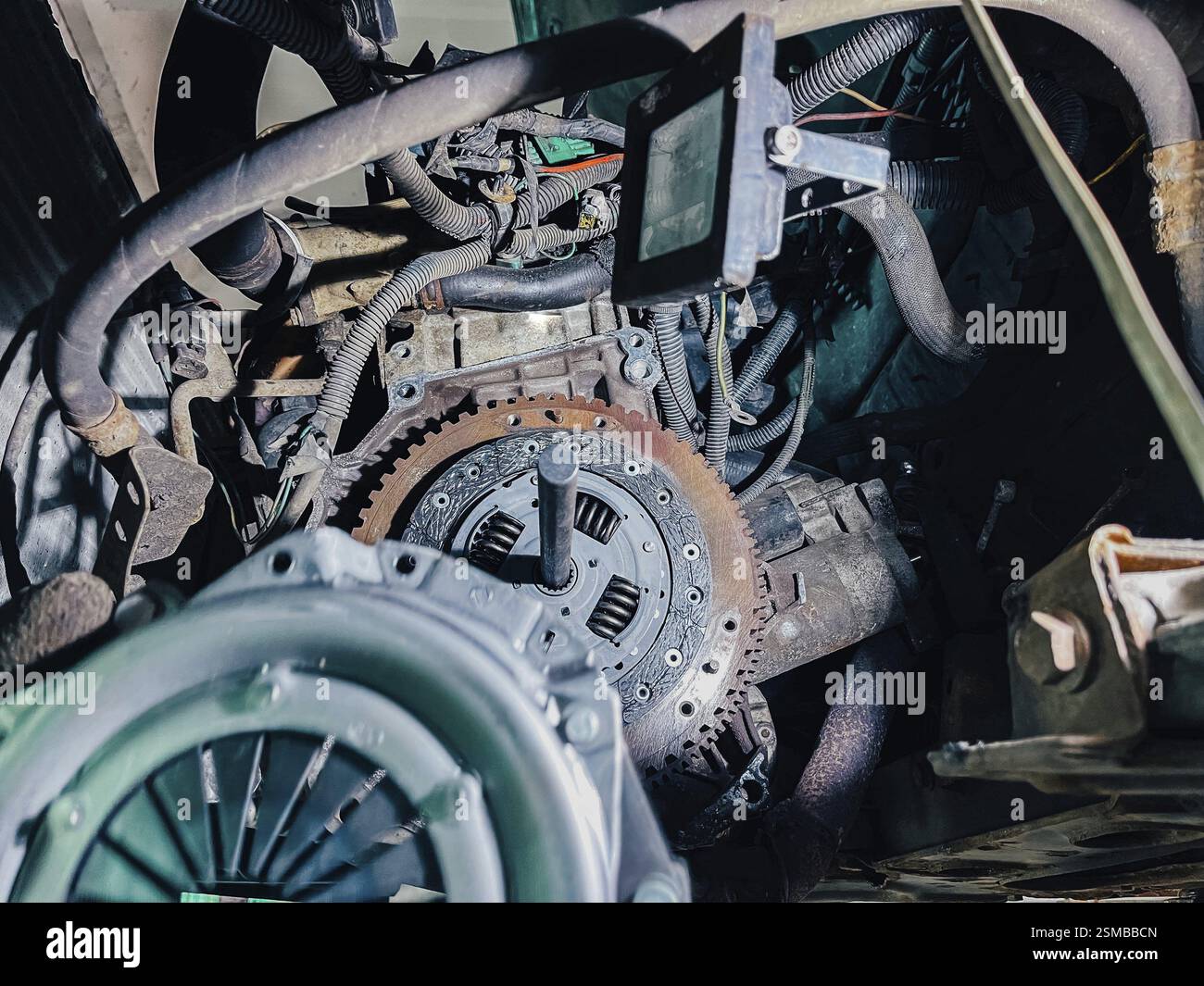 Mechanic examines car engine components for clutch disk installation ...