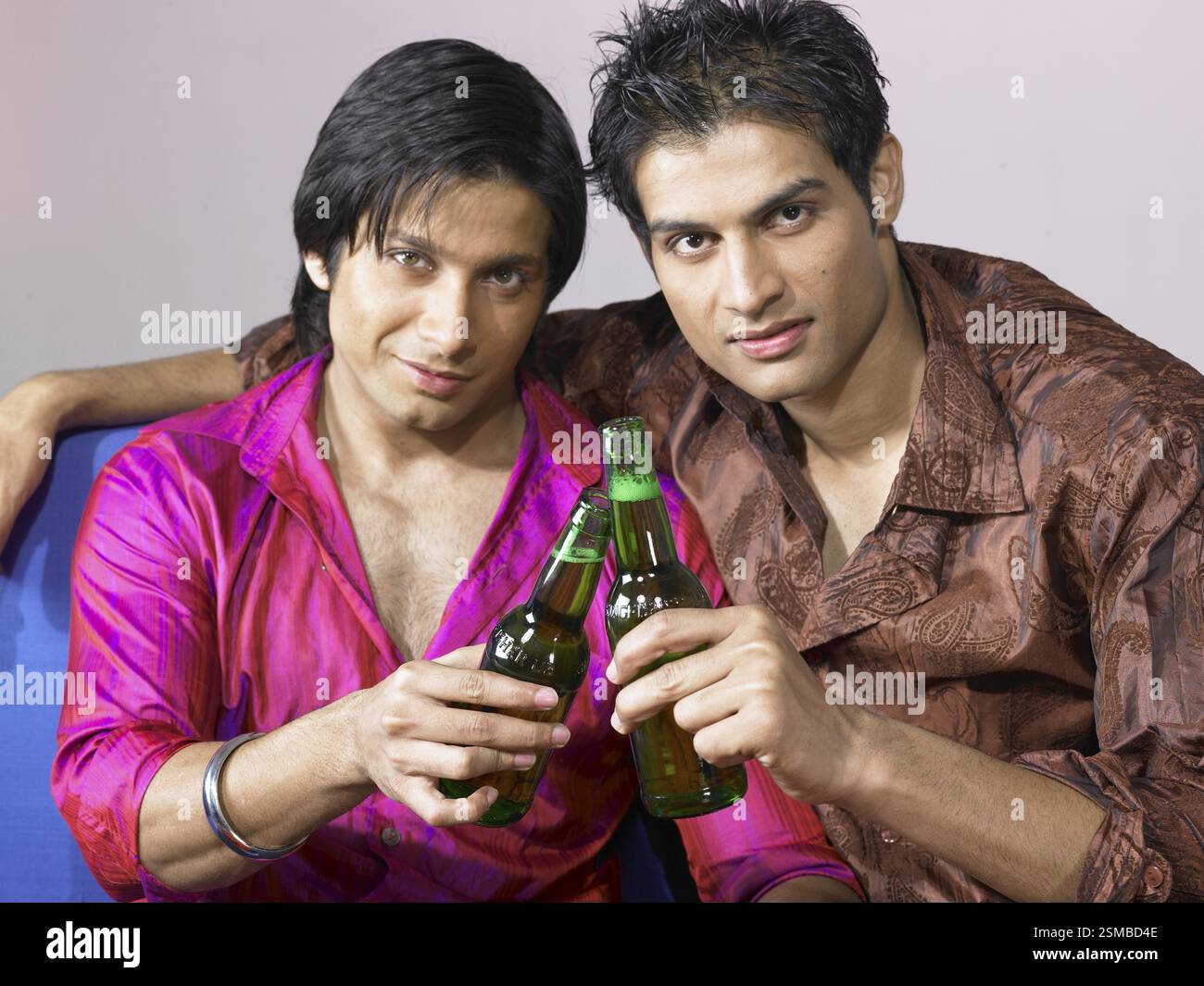 South Asian Indian men toasting drink bottles celebrating party MR ...