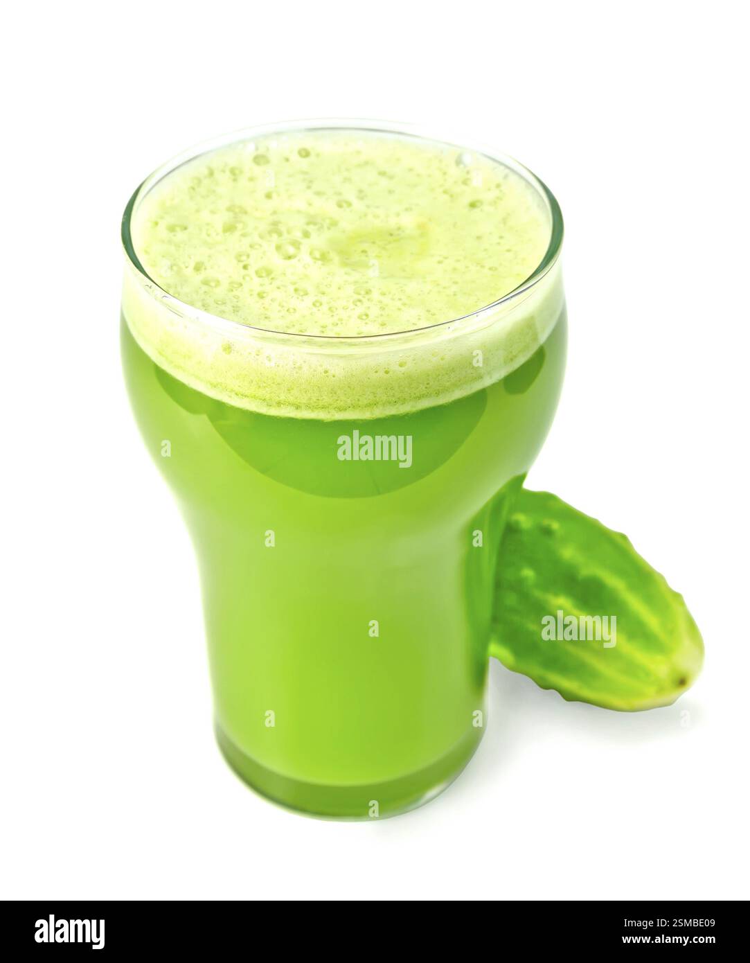 Cucumber juice in a tall glass, a whole cucumber isolated on white ...