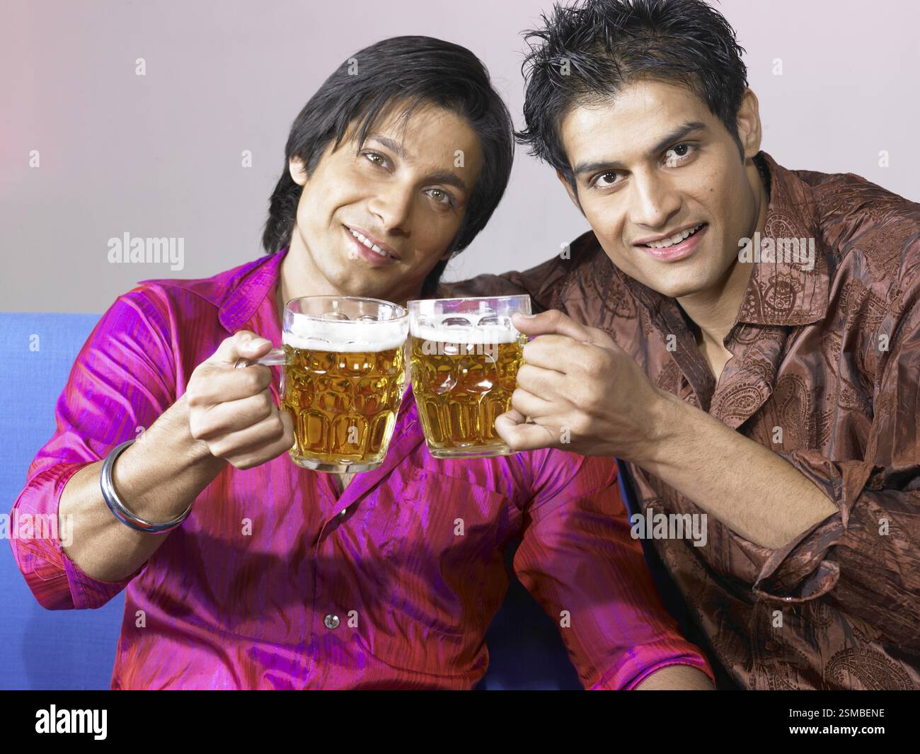 South Asian Indian men toasting drink glasses celebrating party MR ...