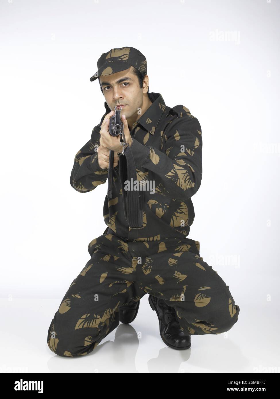 Indian army soldier sitting on knee pointing AK-47 gun MR#702A Stock ...