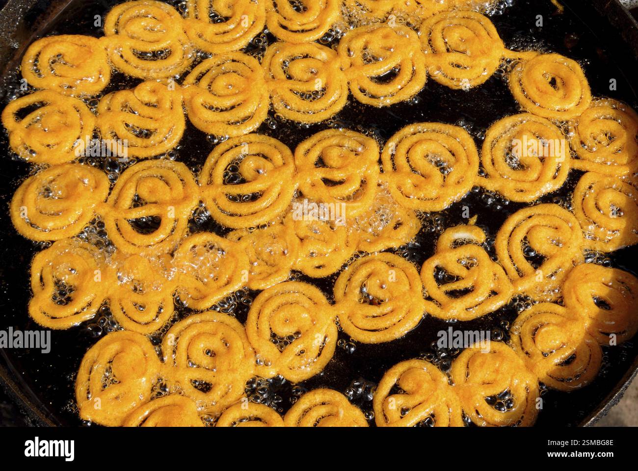 Sweet dish, jalebi yellow color circle deep in sugar water Stock Photo ...